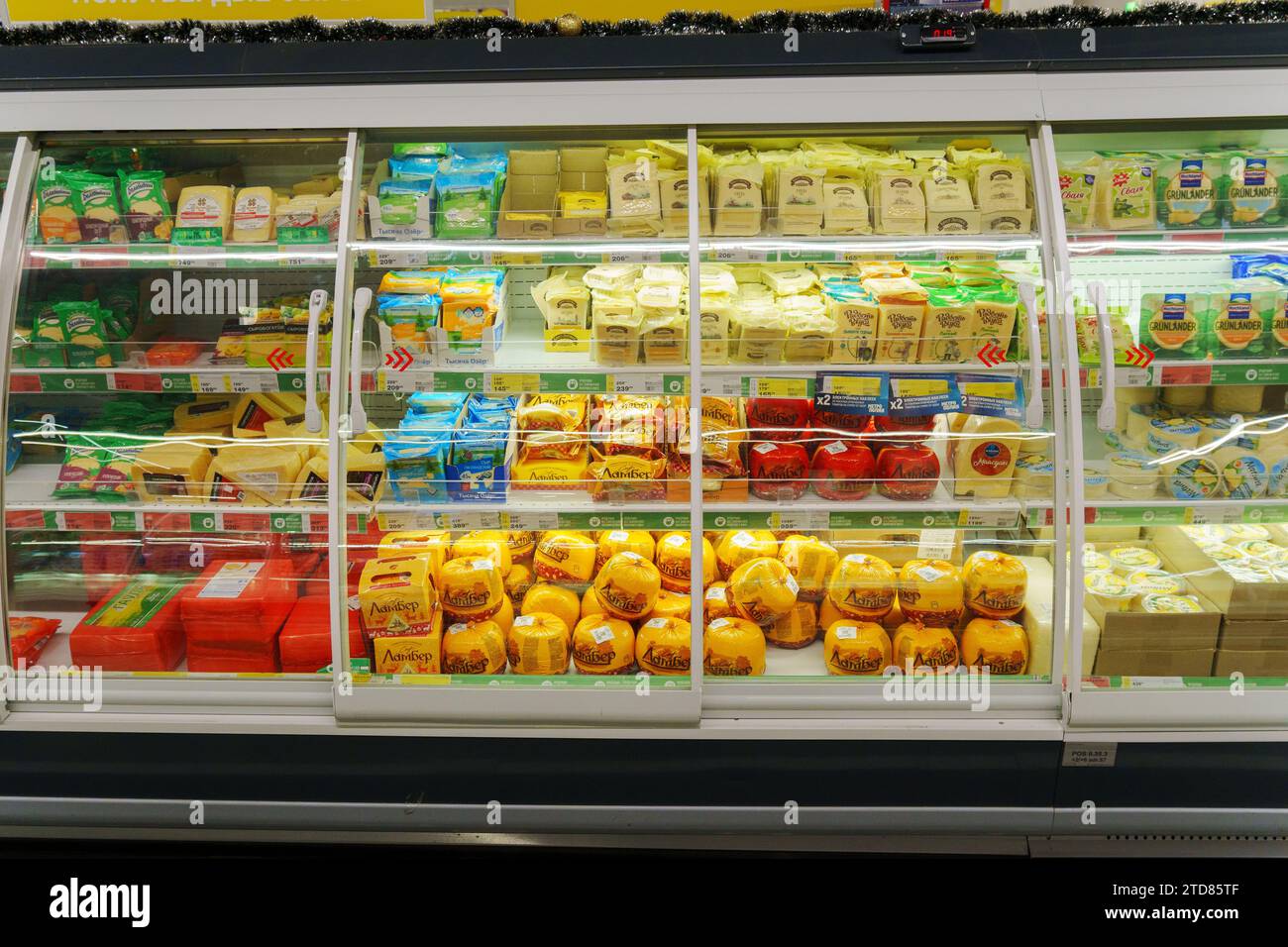 Tyumen, Russia-December 11, 2023: Glass fridge with various dairy ...