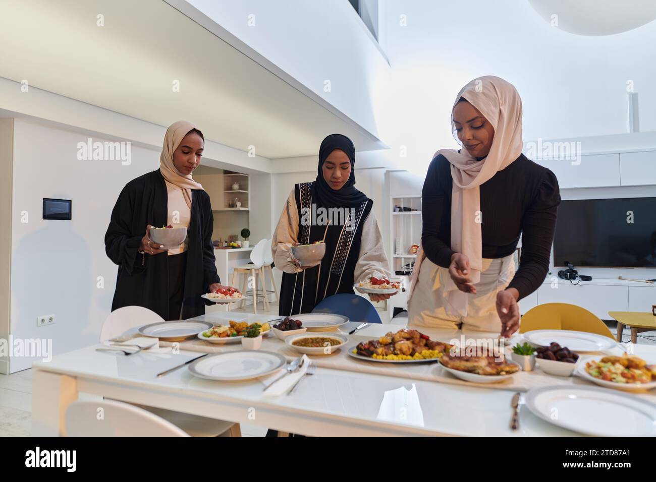 Group of young Arab women come together to lovingly prepare an iftar ...