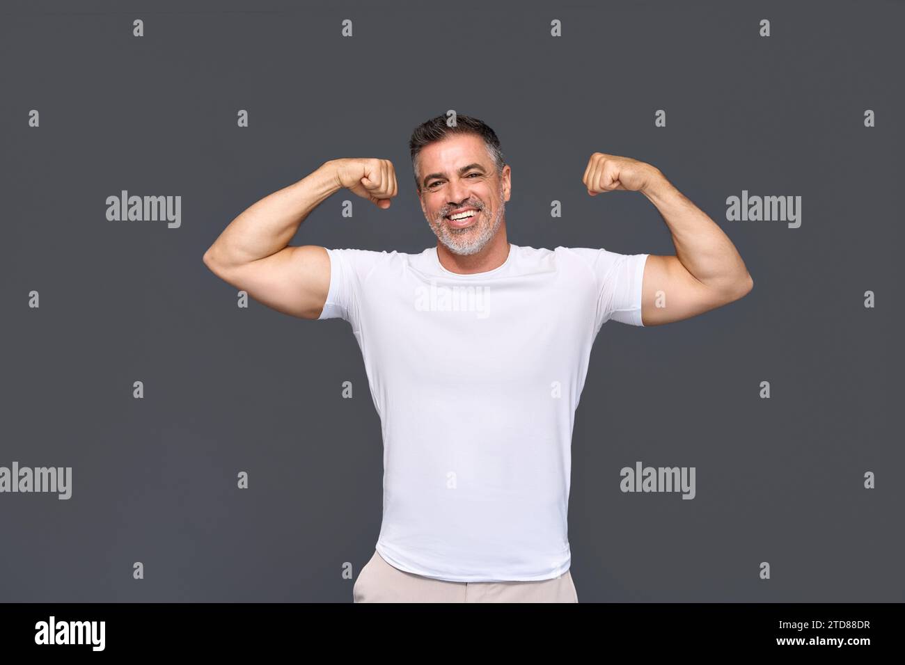 Happy fit sporty older man personal trainer isolated on gray, portrait ...