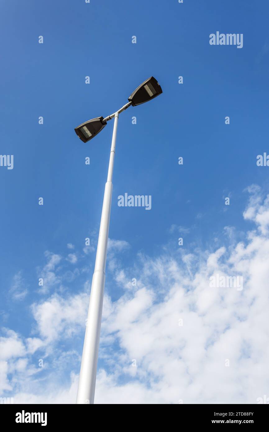 LED street lamp post on blue sky background with white clouds Stock ...