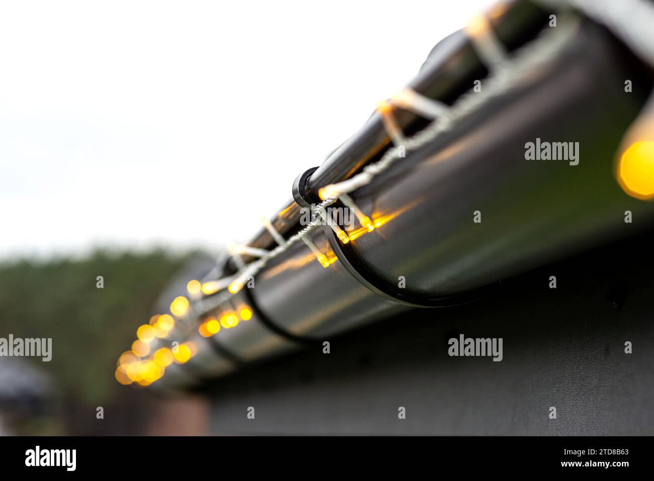 Installing LED lights along the gutter around the house, decorating the ...