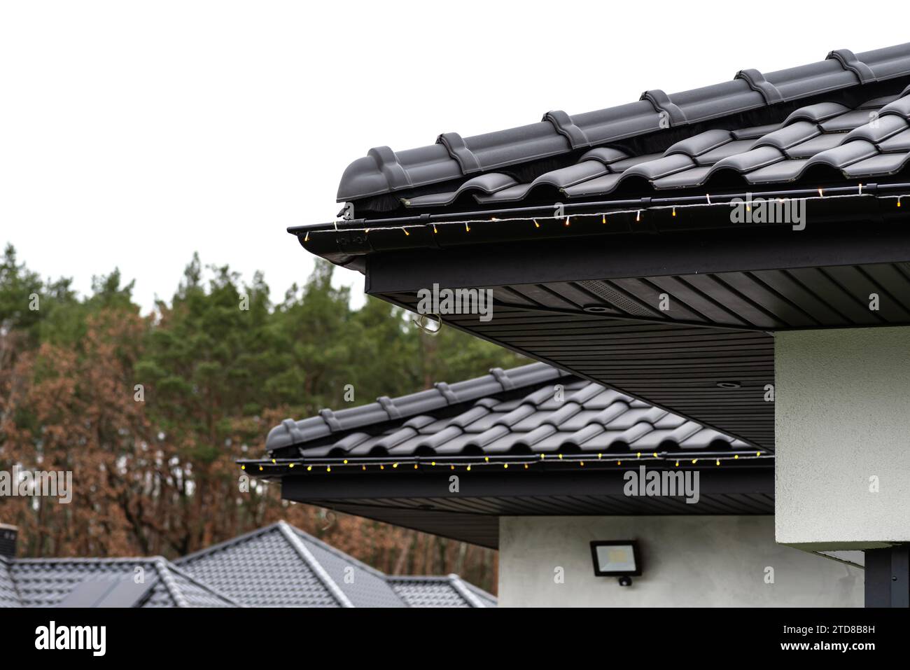 Installing LED lights along the gutter around the house, decorating the ...