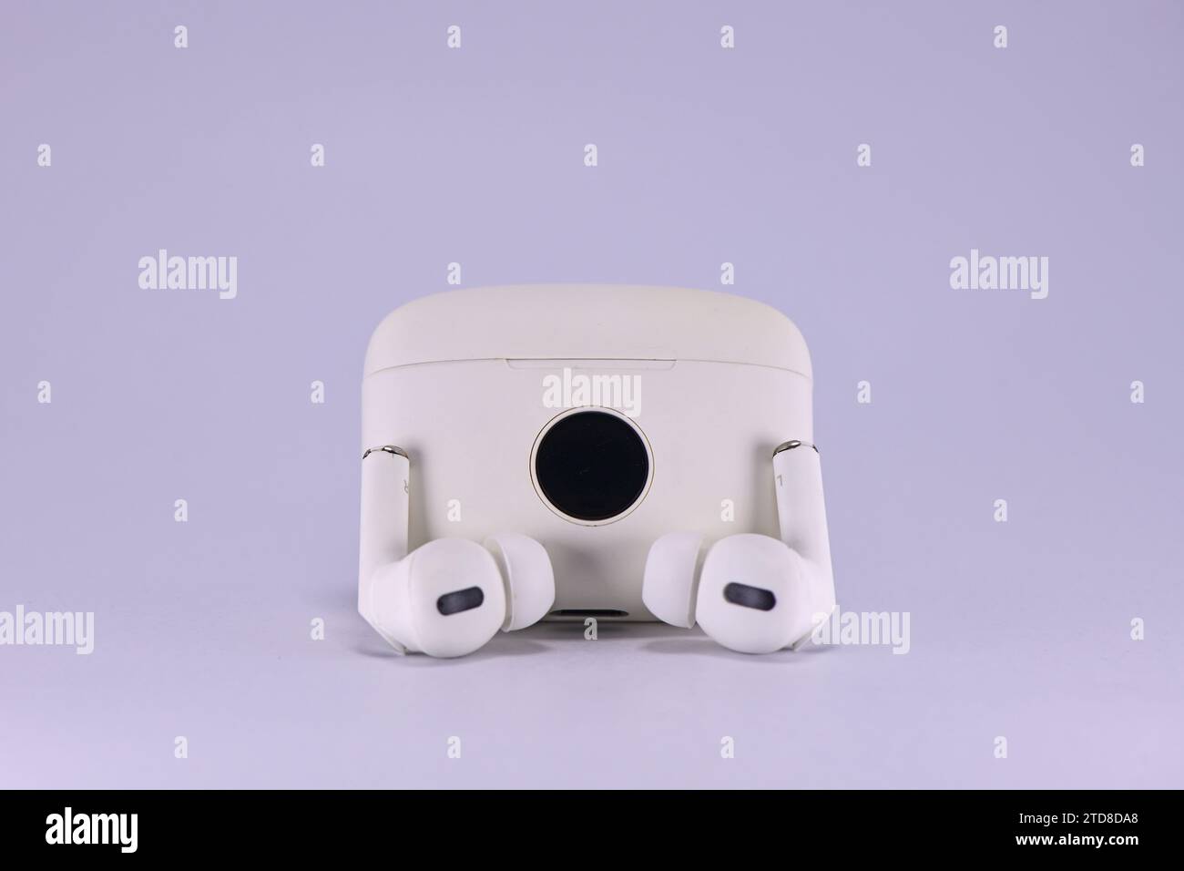 Modern wireless earbuds headphones with charging case isolated on white ...