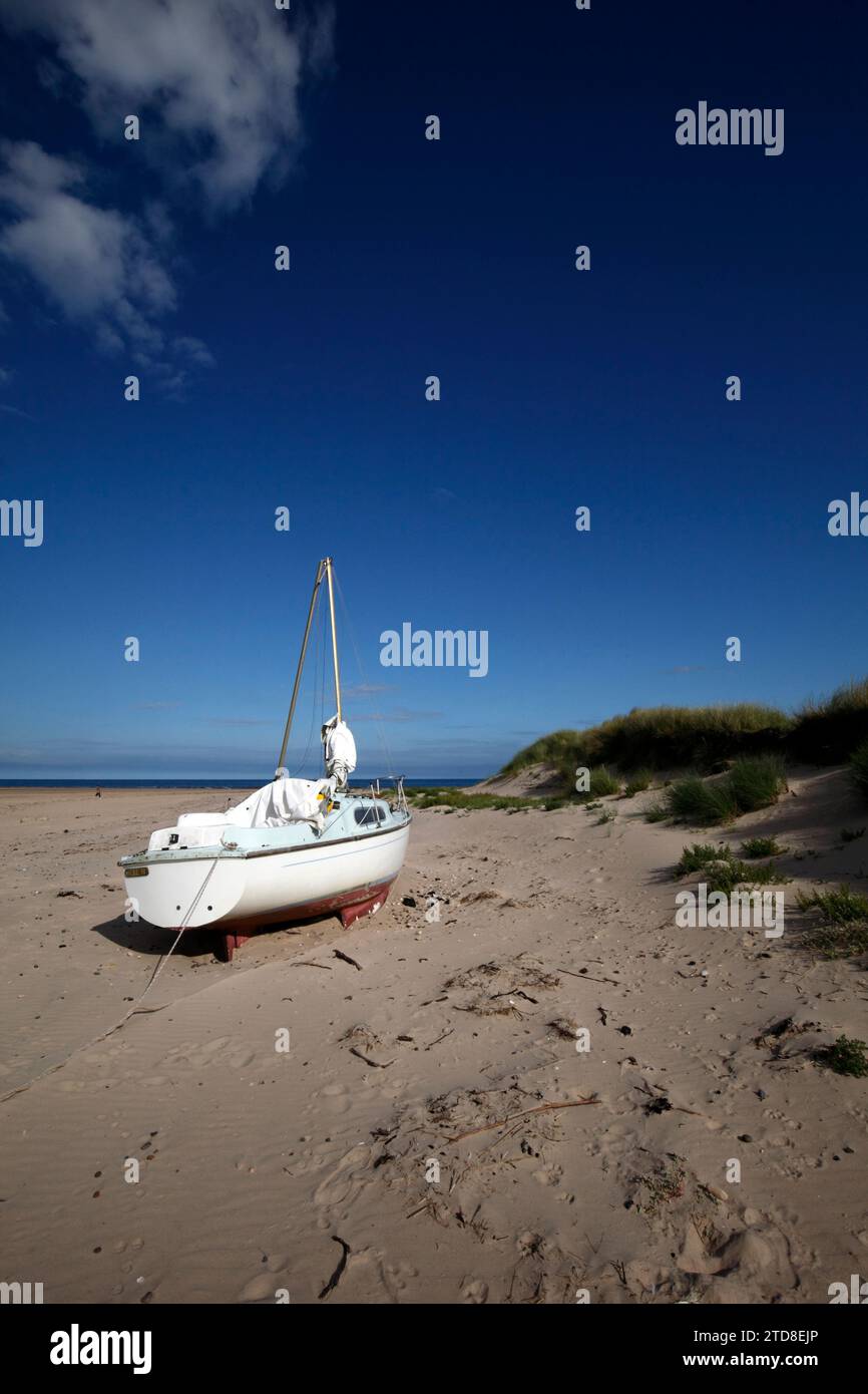 A sailing boat beached as the tide is out, at Alnwick Stock Photo - Alamy