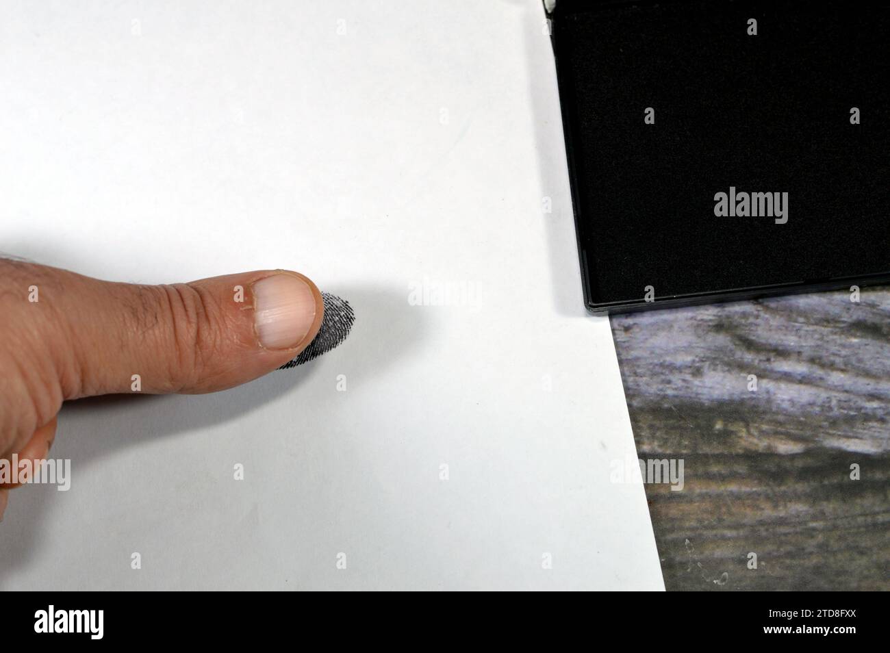 A fingerprint and a black color stamp ink pad, finger print is an ...