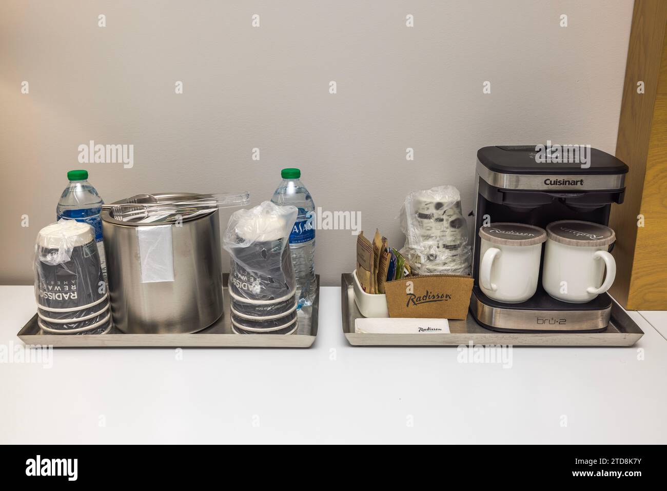 Hotel room table set with guest amenities, including coffee machine and ...