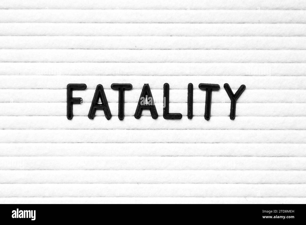 Black color letter in word fatality on white felt board background ...