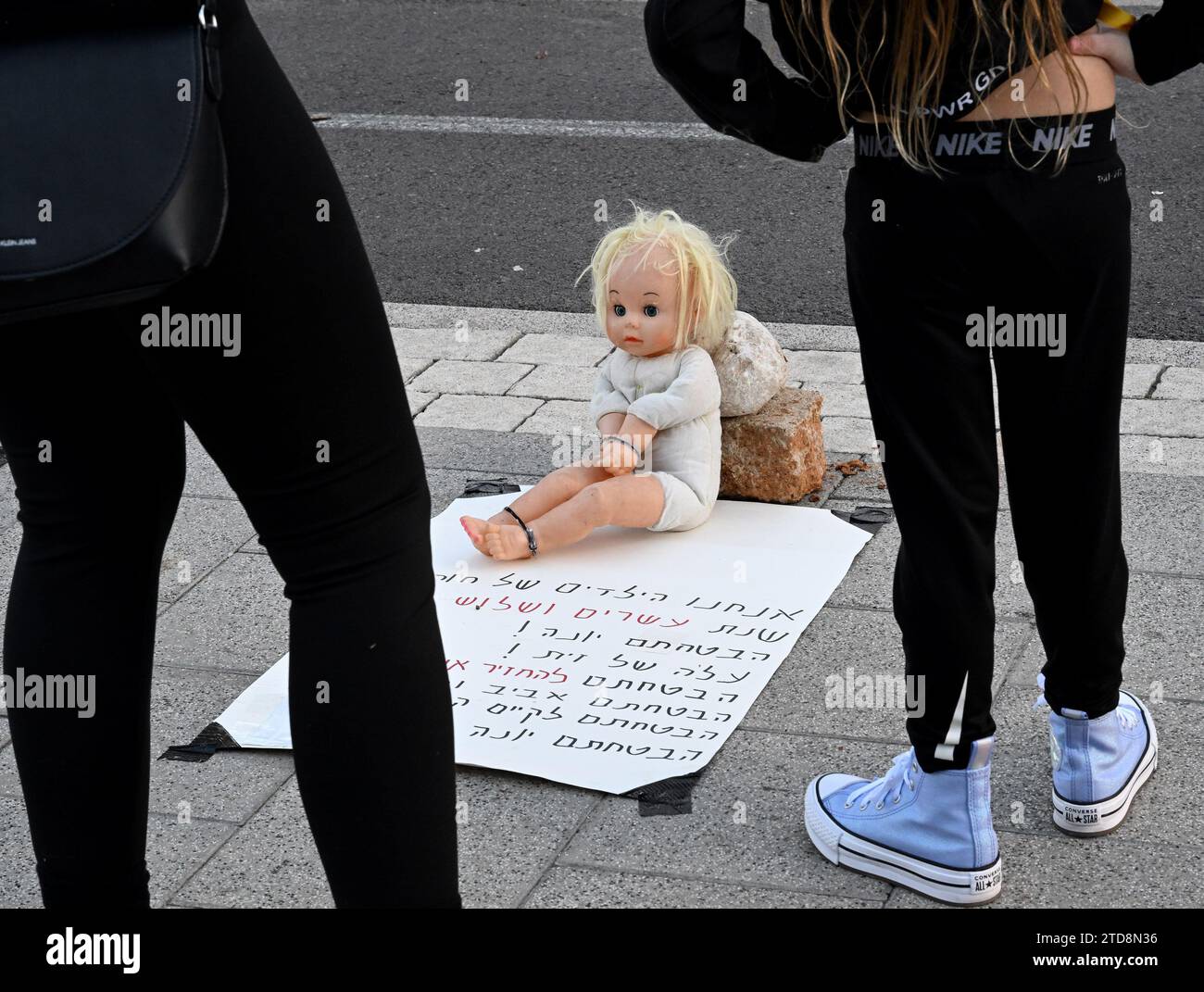 Tel Aviv, Israel. 16th Dec, 2023. People look at a doll representing ...
