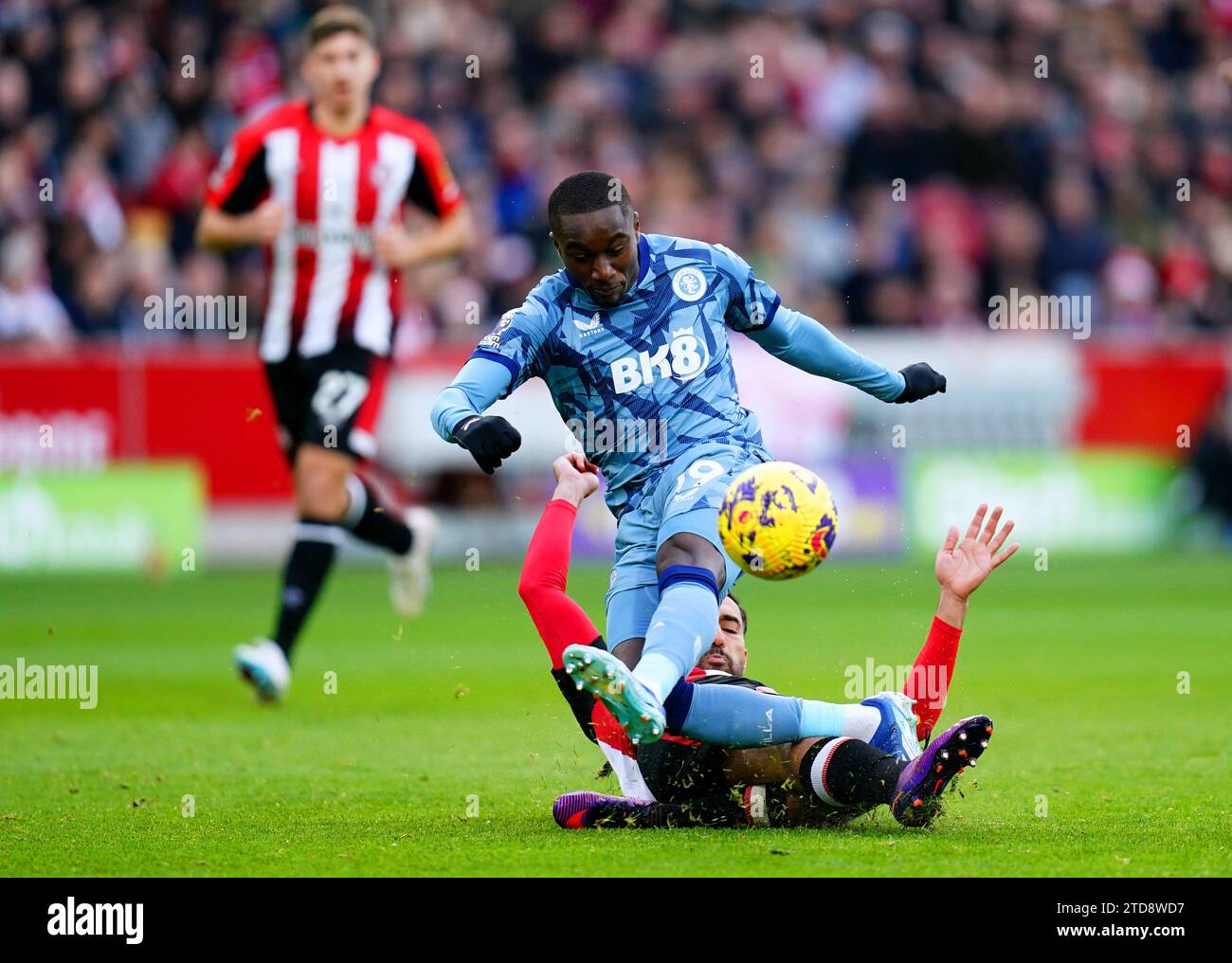 Aston Villa's Moussa Diaby is tackled by Brentford's Saman Ghoddos ...