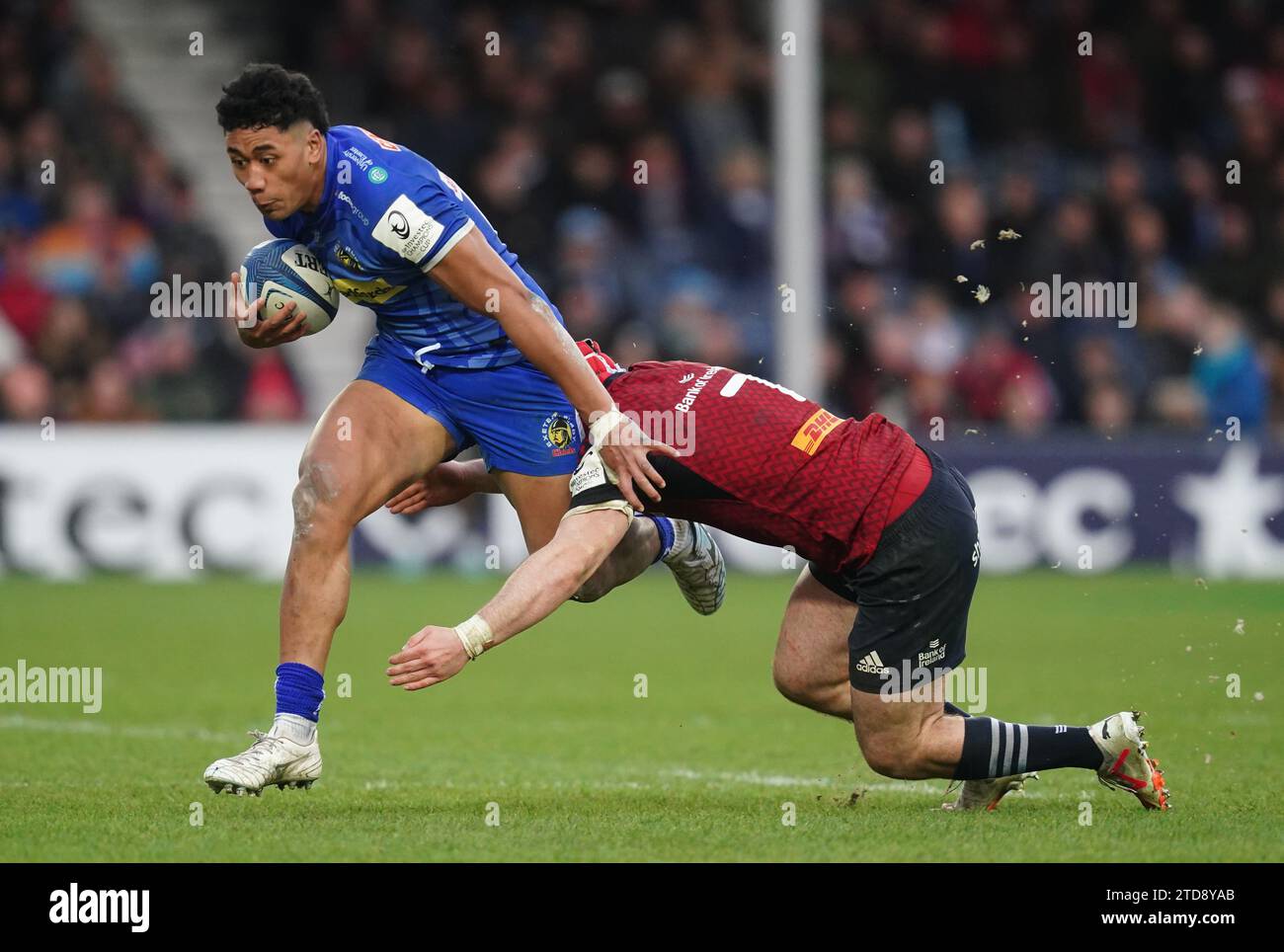 Exeter Chiefs' Greg Fisilau is tackled by Munster's Josh Hodnett during ...