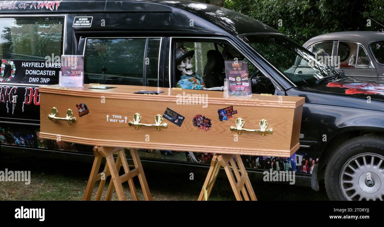 Fun exhibit at bikers show event. Skeleton and hearse Stock Photo - Alamy