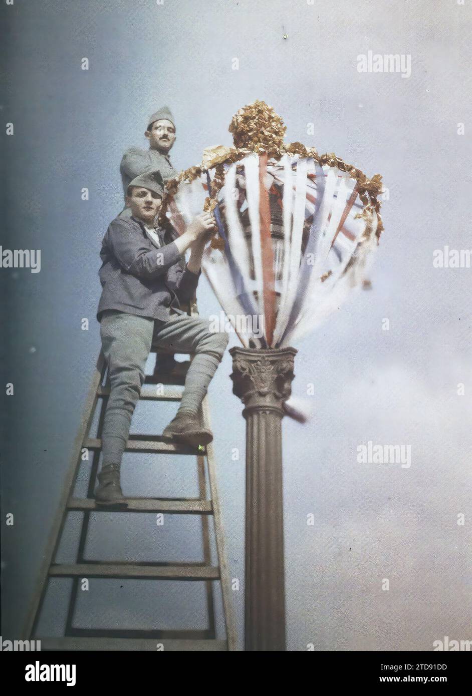 Paris, France Two soldiers decorating a lamp post for the Victory Day ...