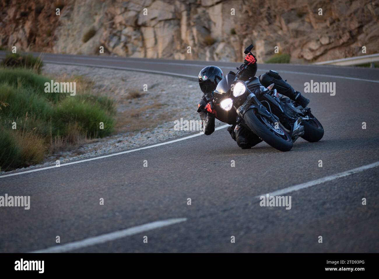 Motorcyclist taking a curve in the port of Navalmoral, province of ...