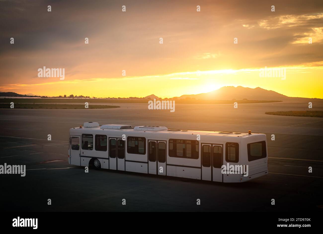Airport shuttle bus in the airport at sunset Stock Photo - Alamy