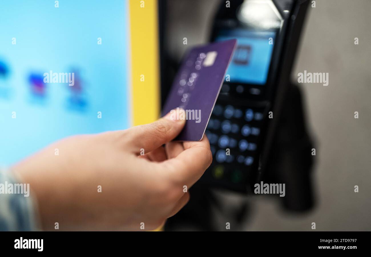 Woman pays with card at a self-service payment terminal Stock Photo - Alamy