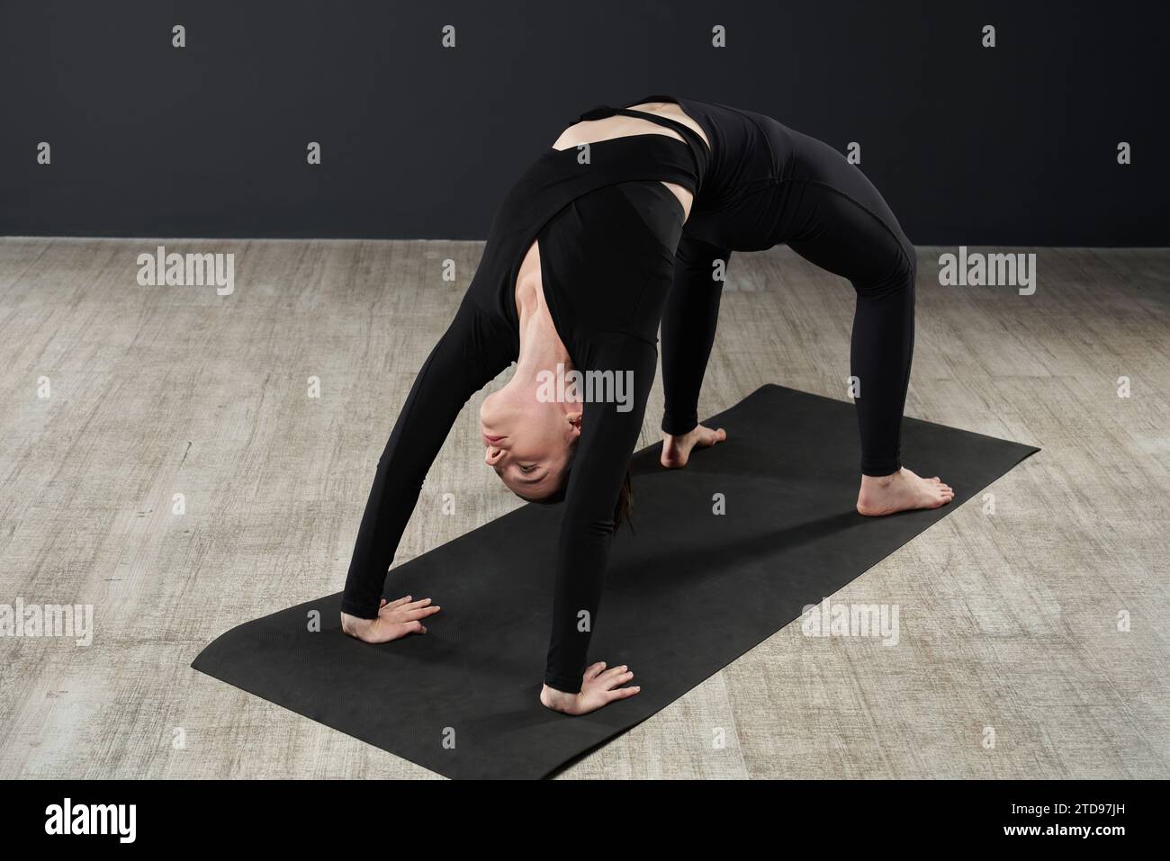 Flexible slim woman doing backbend in yoga studio Stock Photo - Alamy