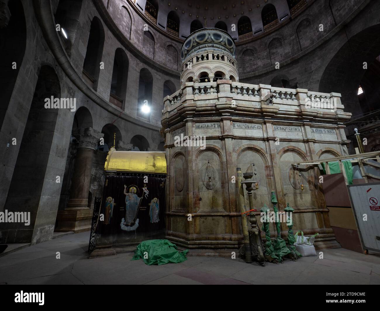 Big candle holders warp in green tarp due to the renovations near the ...