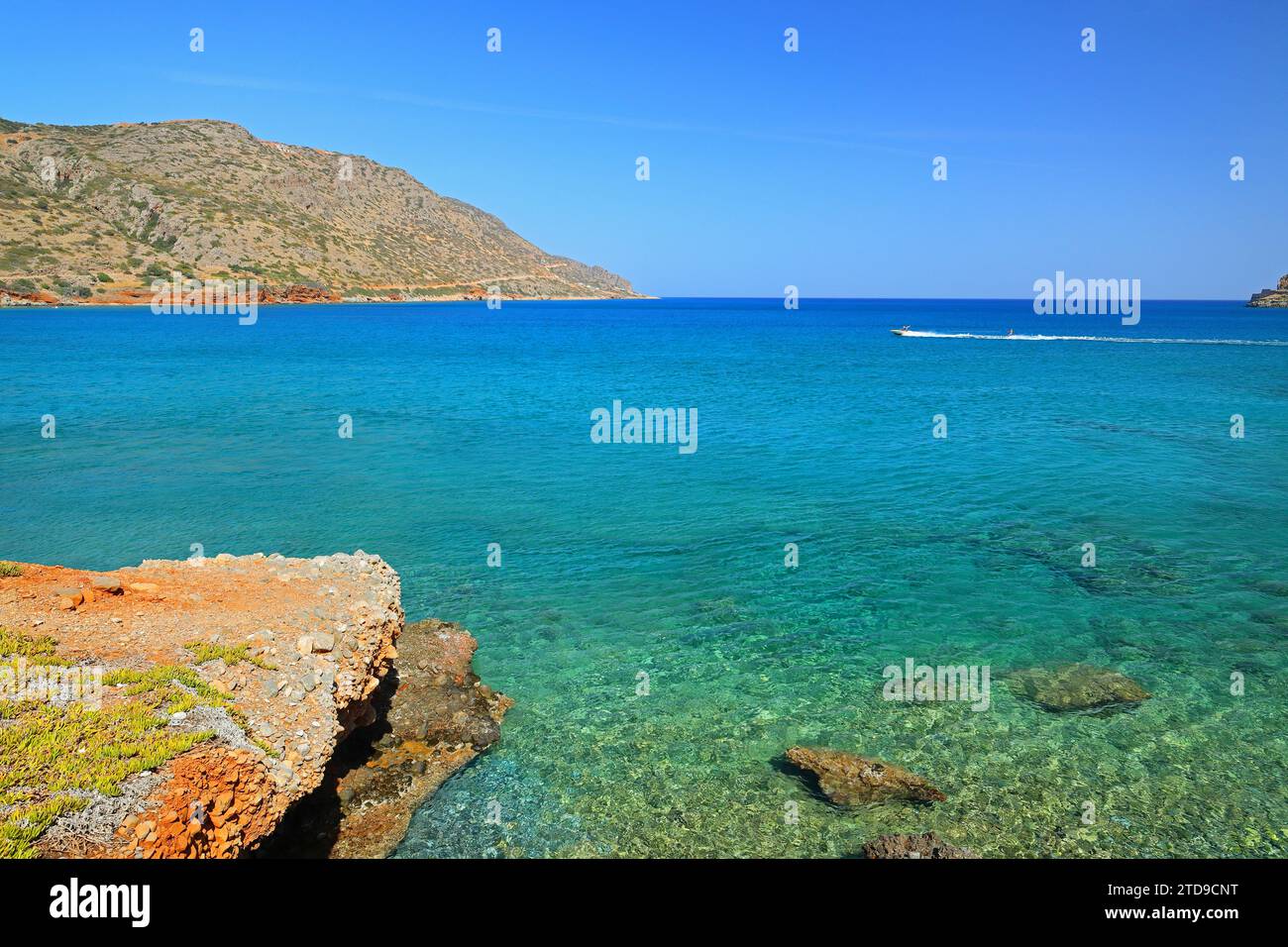 View from Plake looking over the Gulf of Elounda with people water ...