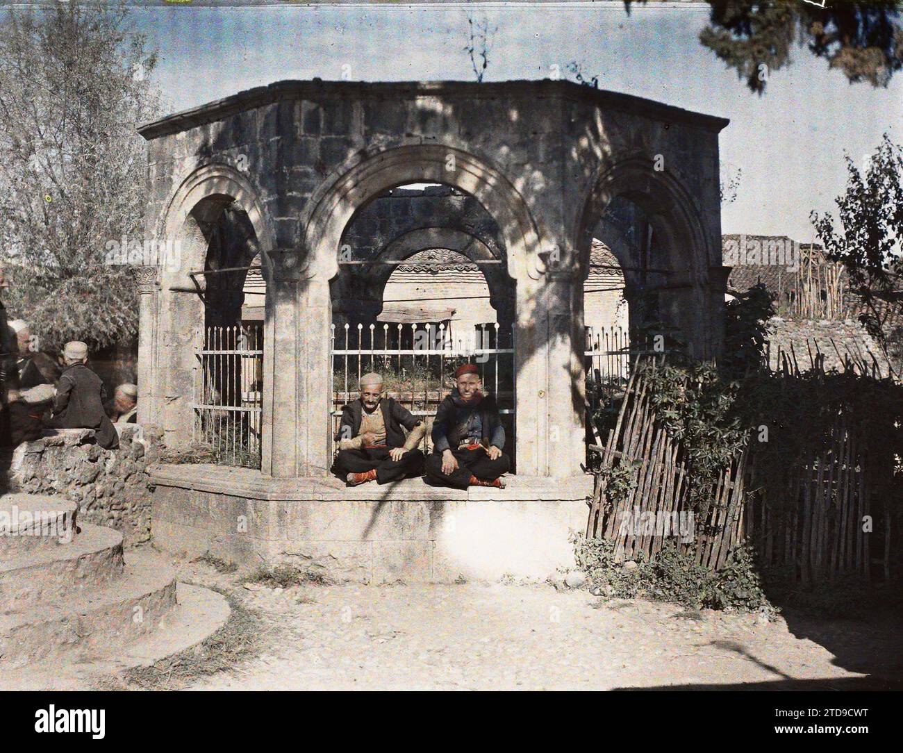 Tirana, Albania Two men sitting under the arcades of the türbe ...