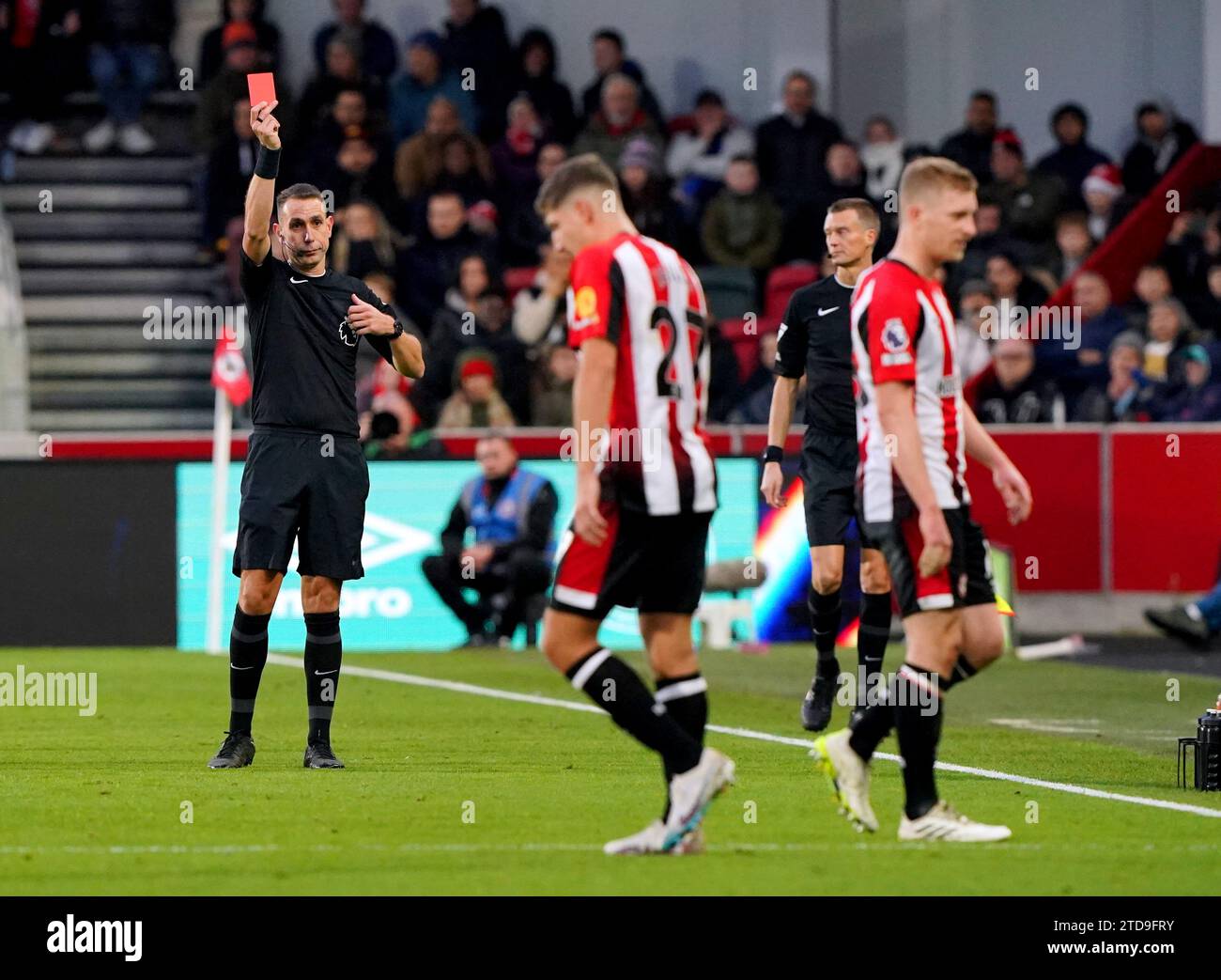 Referee David Coote shows a red card to Brentford's Ben Mee during the ...