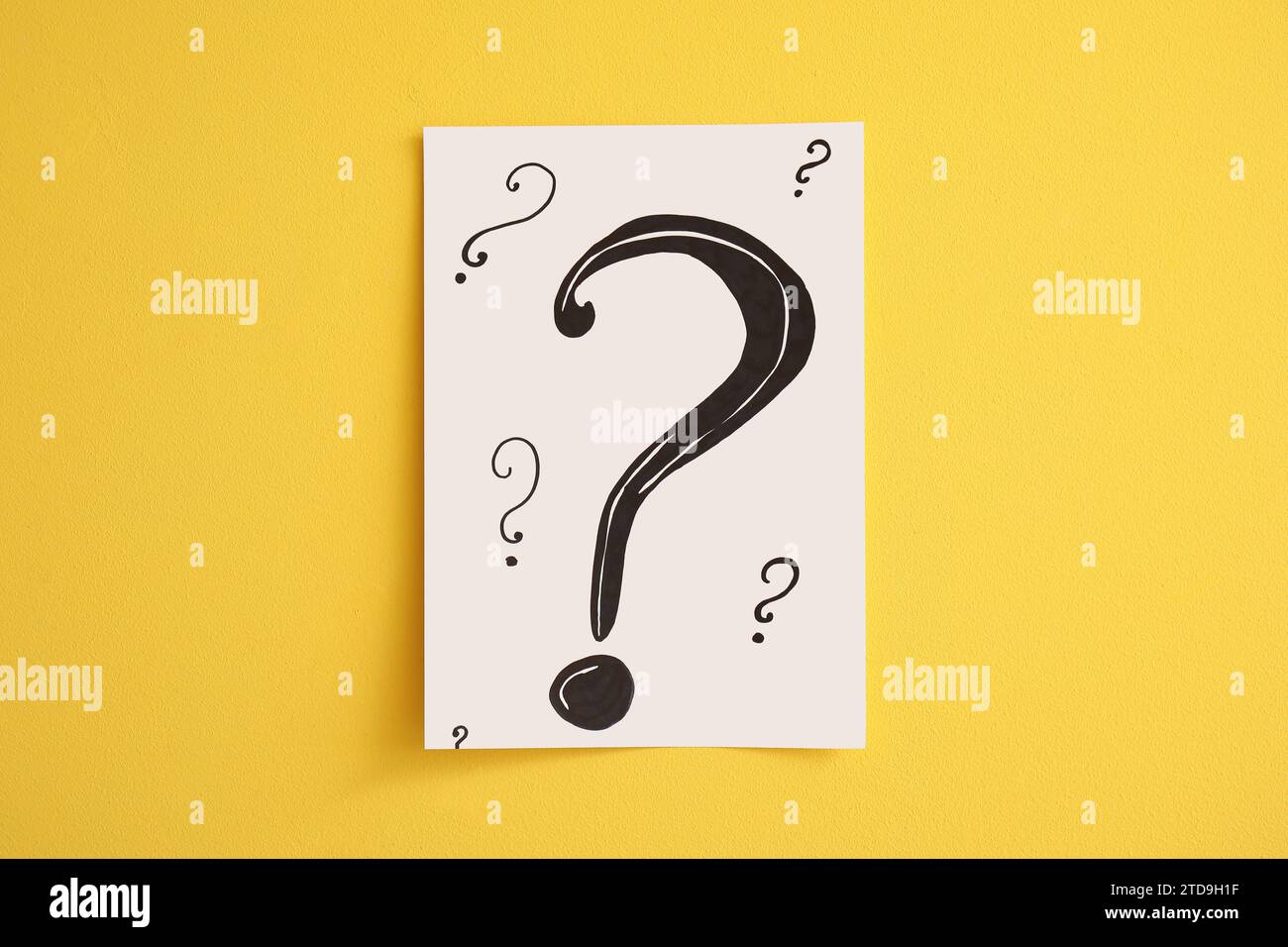 Paper with question marks on yellow background Stock Photo - Alamy