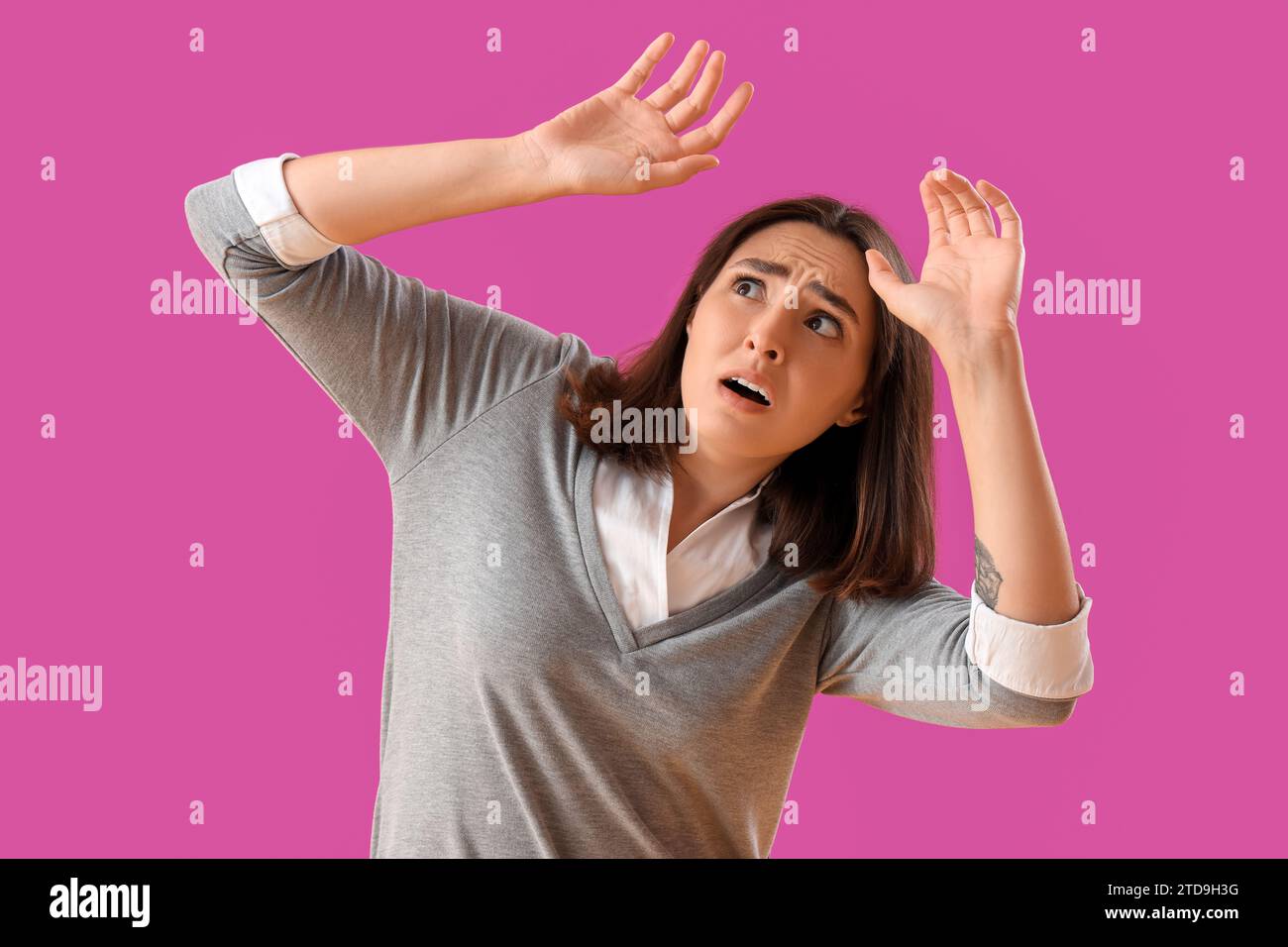 Beautiful young afraid woman on purple background Stock Photo - Alamy