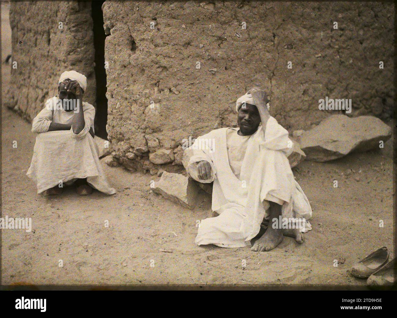 Aswan, Egypt, Africa Two Sudanese sitting on the ground in the village ...