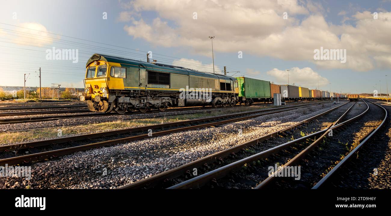 Profile view of a goods train with Intermodal wagons full of shipping ...