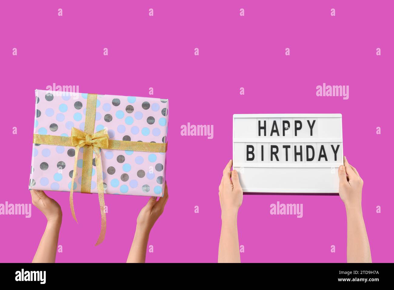 Female hands holding gift box and board with text HAPPY BIRTHDAY on ...
