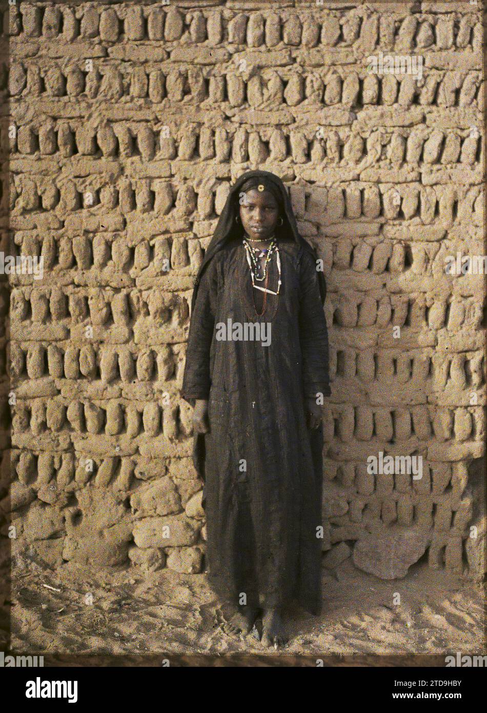 Aswan, Egypt, Africa Young Berber girl posing in front of an adobe wall, Human beings, Clothing ...