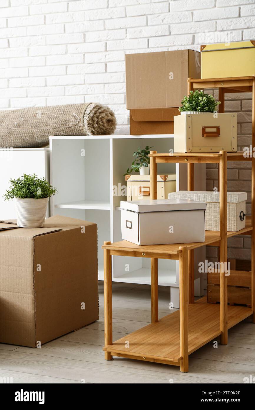 Cardboard boxes with shelf units in living room on moving day Stock ...