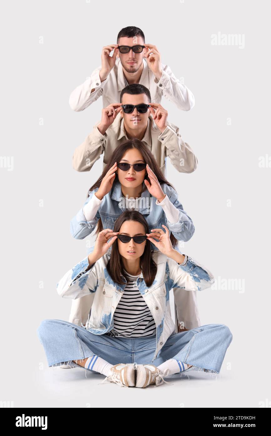 Group of young people in stylish denim clothes on white background ...