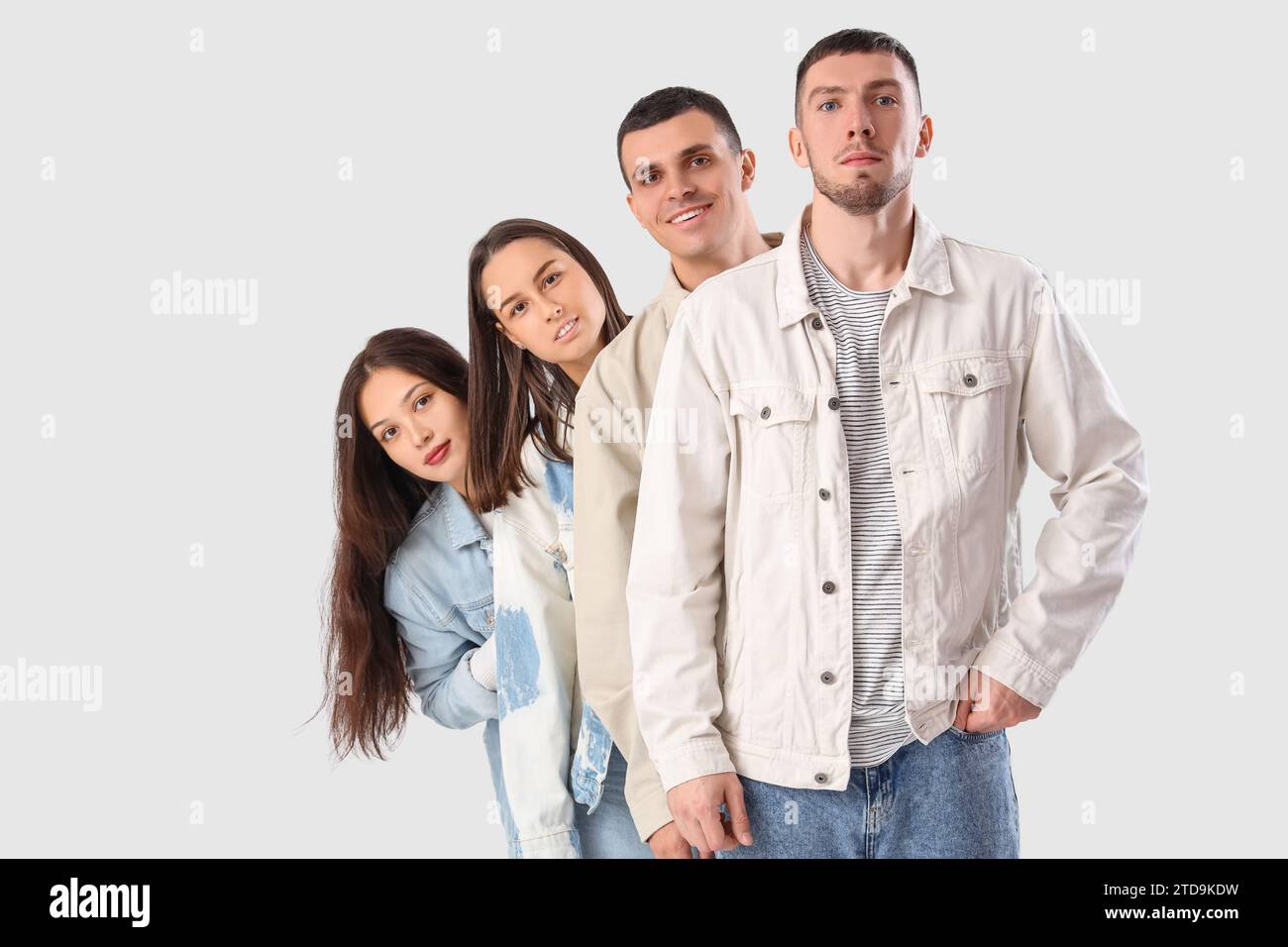 Group of young people in stylish denim jackets on white background ...