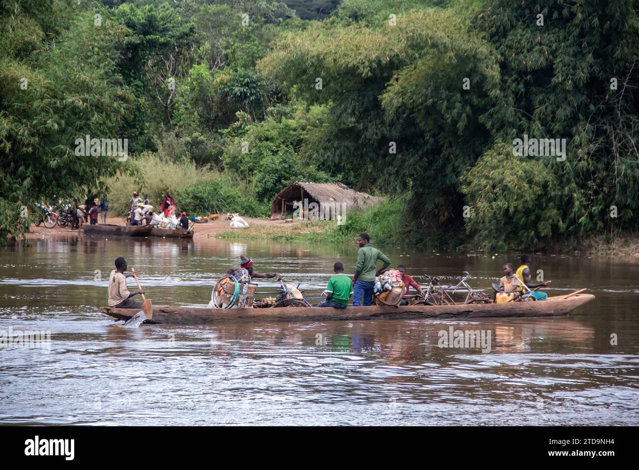 Transport of people across the Mbari river by locally made canoes and ...