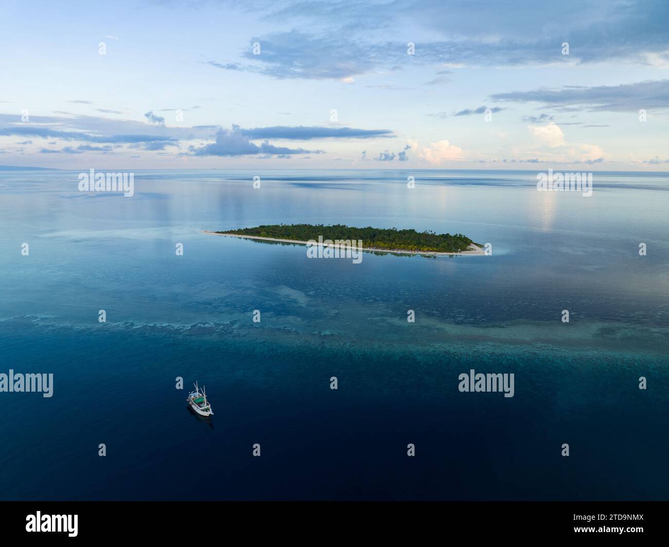 Sunrise illuminates the remote island of Koon near Seram, Indonesia ...
