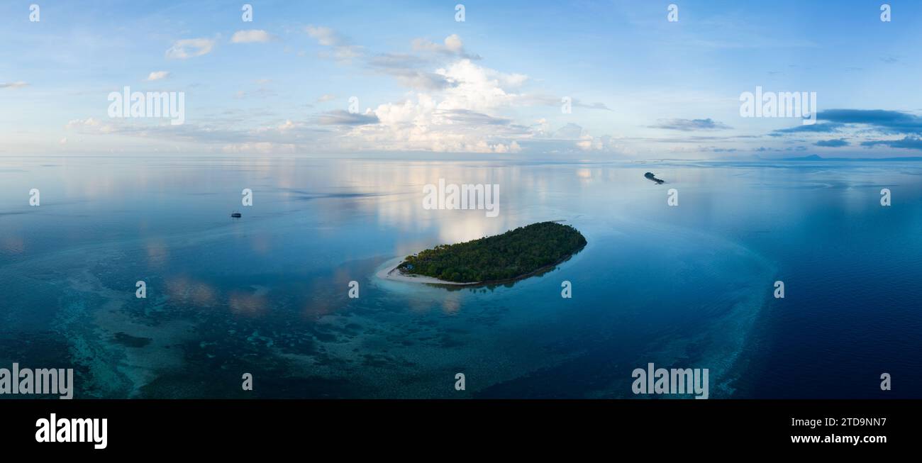 Sunrise illuminates the remote island of Koon near Seram, Indonesia ...