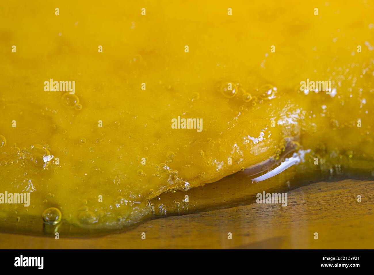 Macro photography of melted cheddar cheese Stock Photo - Alamy