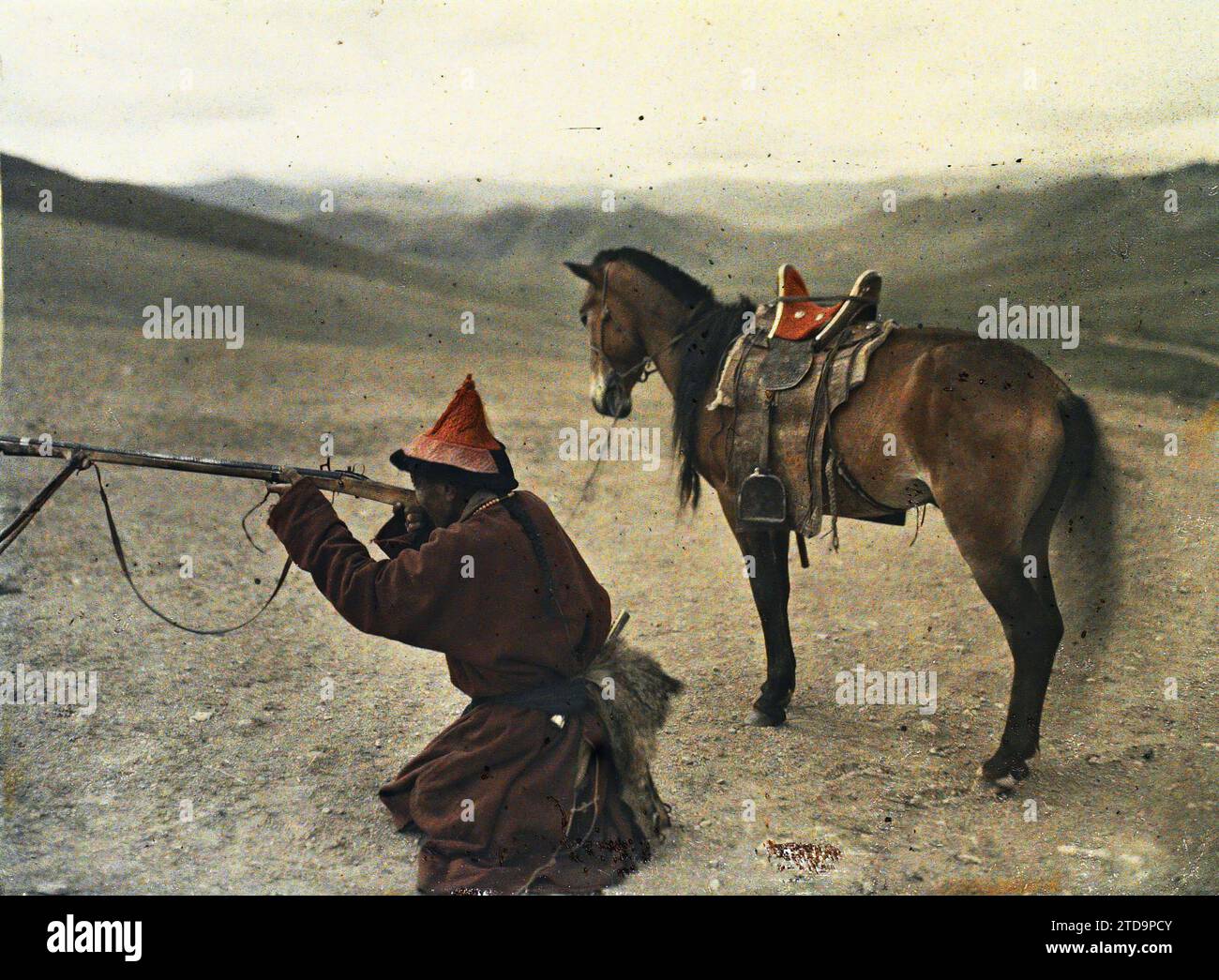 Around Ourga, Mongolia Mongolian hunter dismounted demonstrating flint ...