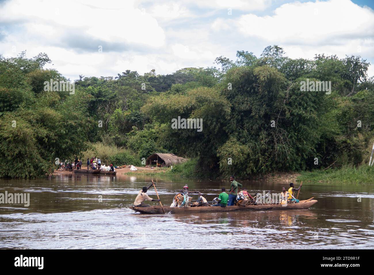 Transport of people across the Mbari river by locally made canoes and ...