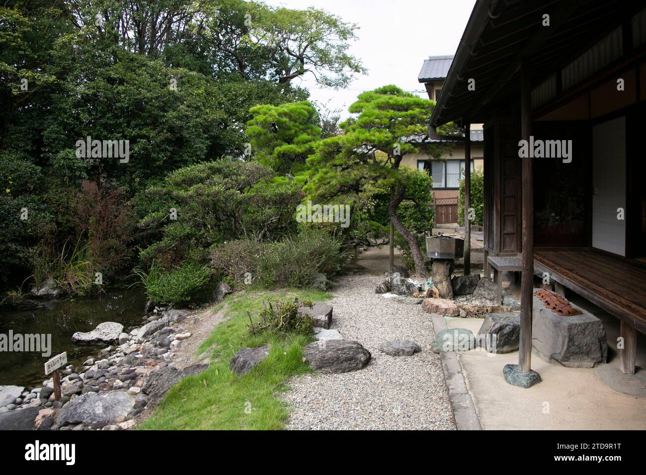 Views of an old Japanese style house with its garden and a small lake ...
