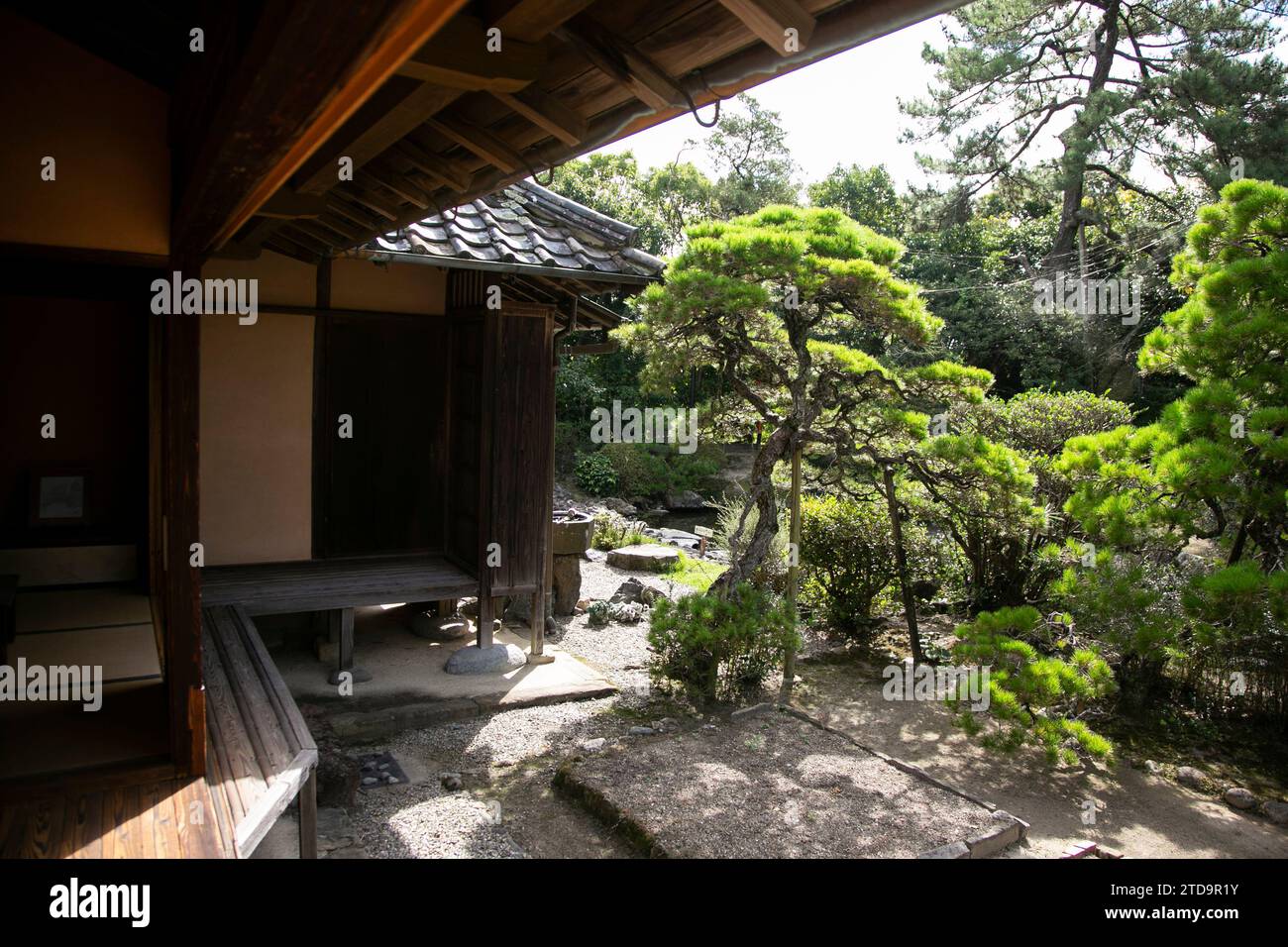 Views of an old Japanese style house with its garden and a small lake ...