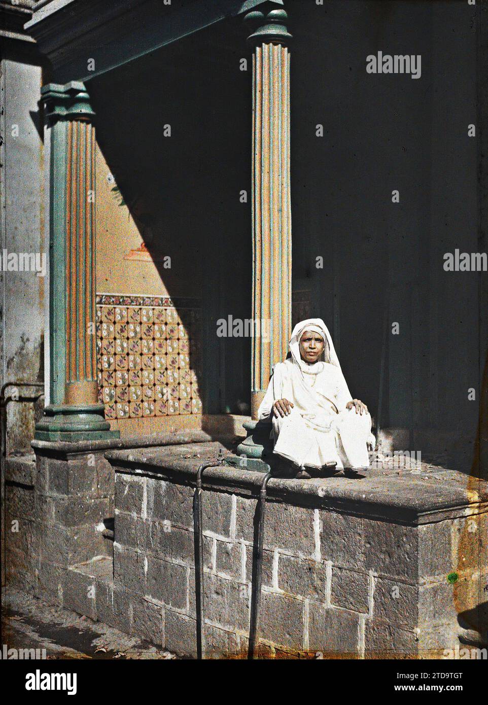 Bombay, India A Hindu woman dressed in white, sitting on the terrace of ...