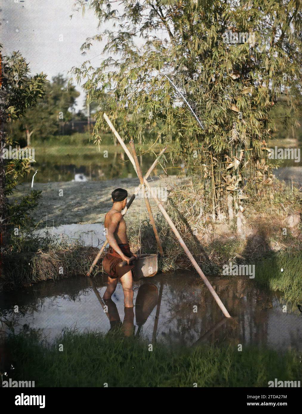 Tonkin, Indochina A man using a handled bucket, water lifting system ...