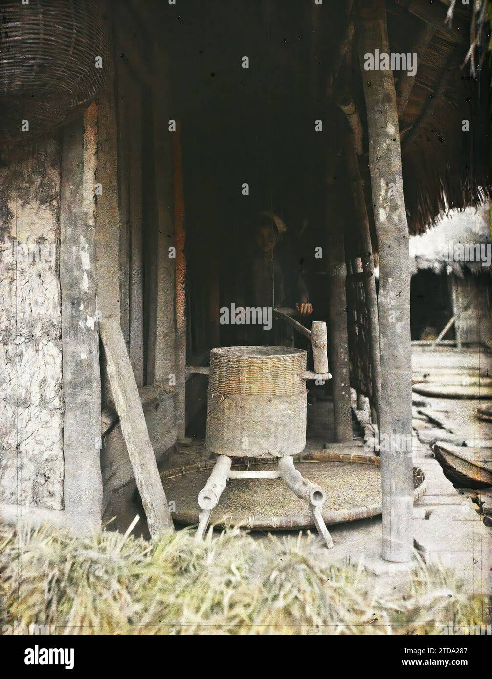 Tonkin, Indochina A young girl operating a paddy hulling mill, in a ...