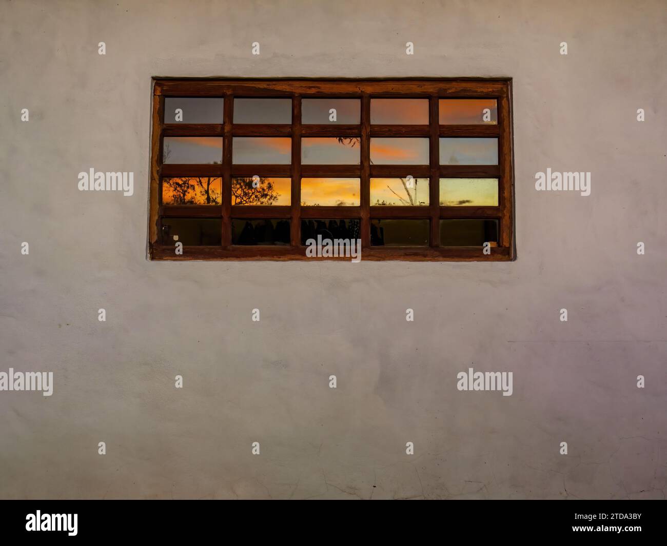The beautiful colors of the afterglow reflecting in a wooden paneled ...