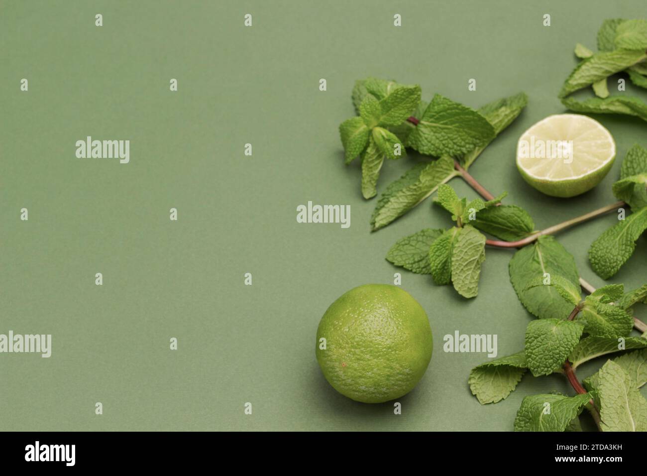 Lime and mint on green background. Copy space. Top view. Alternative ...