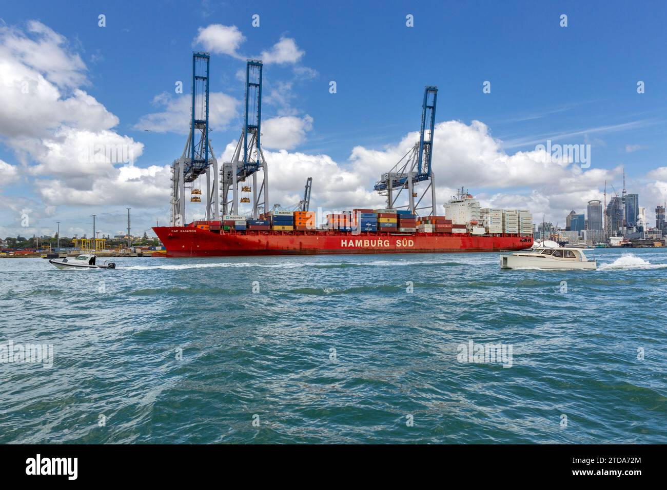 Small motorboats and Cap Jackson Hamburg Sud container ship along side ...