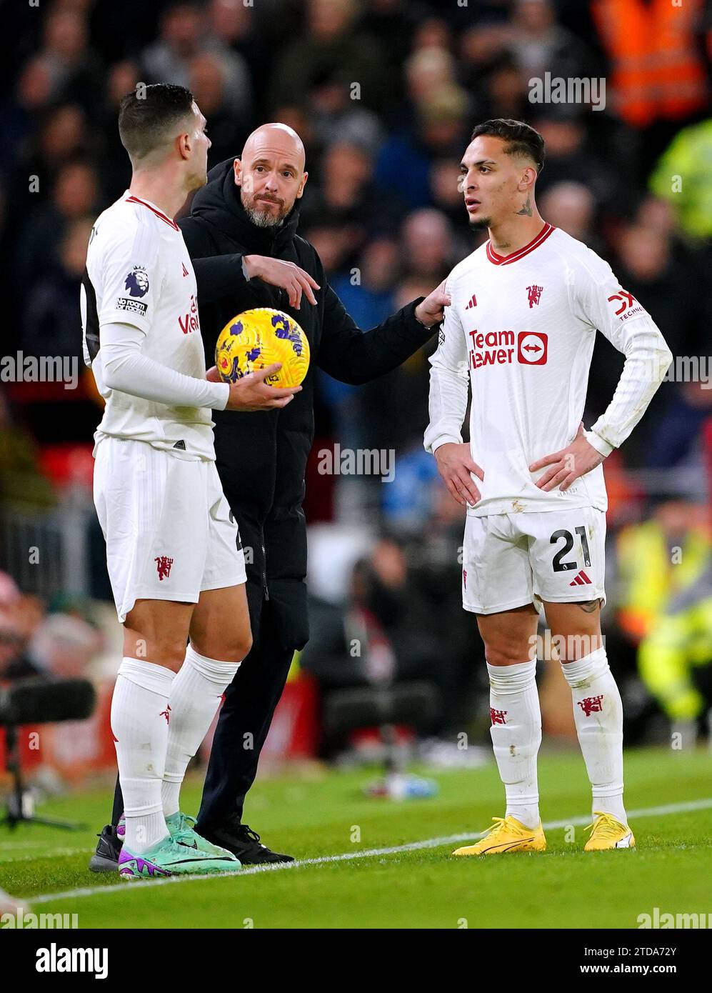 Manchester United manager Erik ten Hag speaks to Antony (right) and ...