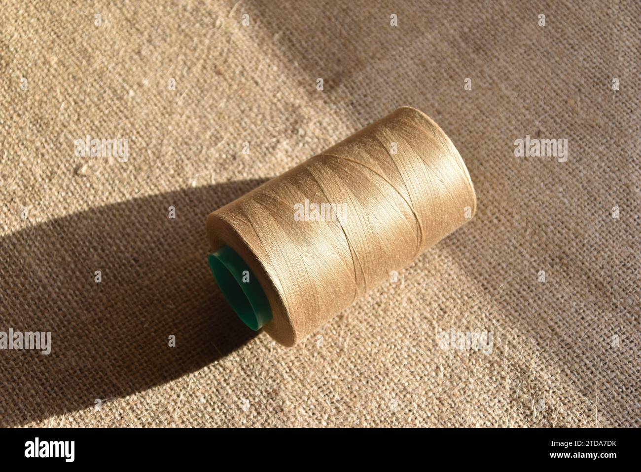 Skeins of thread on burlap. Yellow threads on coarse cloth Stock Photo ...