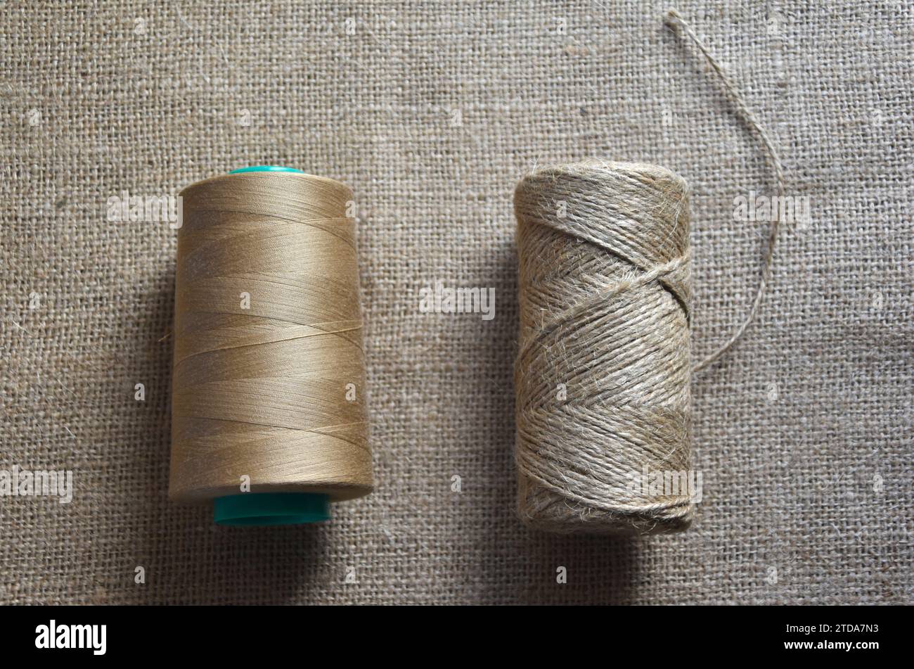 Skeins of thread on burlap. Yellow threads on coarse cloth Stock Photo ...
